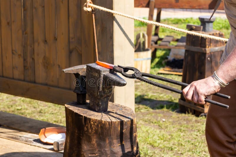 Traditional Blacksmith`s Workshop, Anvil Blacksmith Forms a Sword from ...