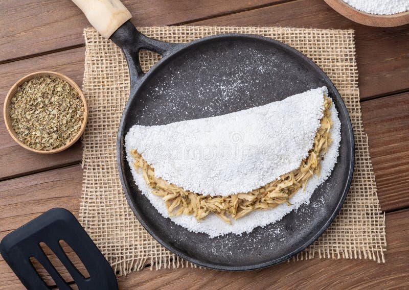 Traditional Brazilian Chicken Stuffed Tapioca on a Pan with Ingredients ...