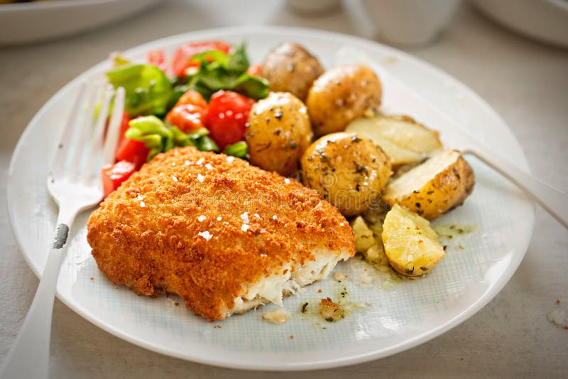 Traditional Breaded Fillet of Cod with Baby Potatoes and Salad Stock ...