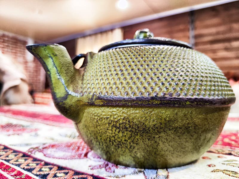 Traditional Cast Iron Teapot on an Oriental Rug. Cast Iron Teapot ...
