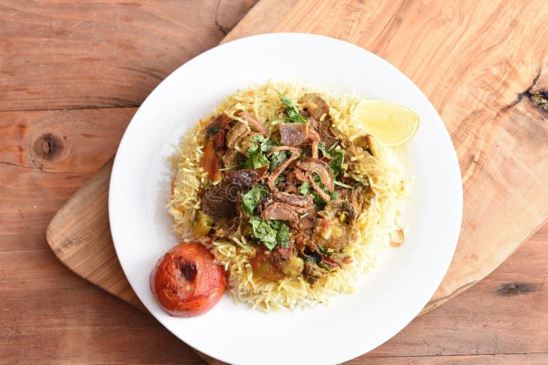 Traditional Chicken Biryani Dish on a Plate with a Wooden Background ...