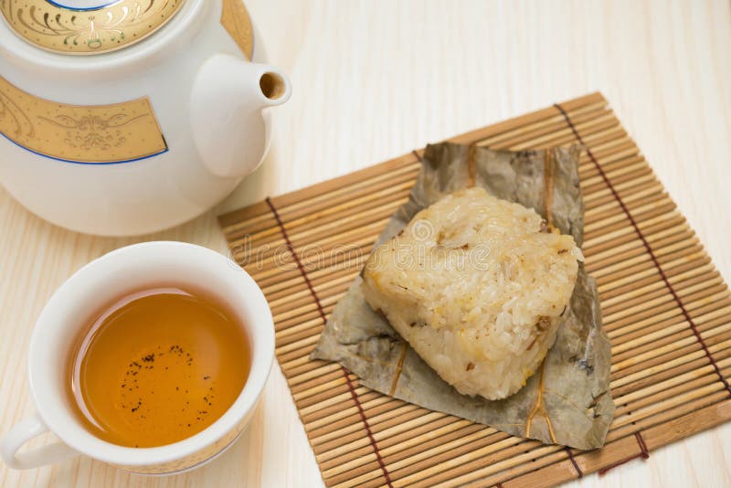 Traditional Chinese Glutinous Rice Dumpling with Cup of Tea and Teapot ...