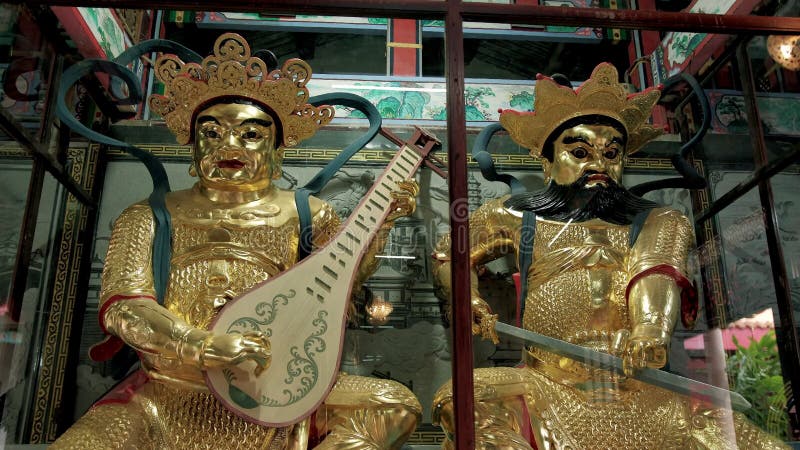 Traditional Chinese Temple Interior Featuring Gilded Deity Statues ...