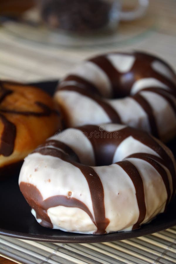 Traditional Donuts with Brown Chocolate on a Plate on a Table Stock ...