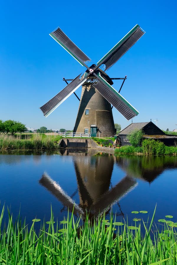 Dutch Windmill Over River Waters Stock Photo - Image of rustic ...