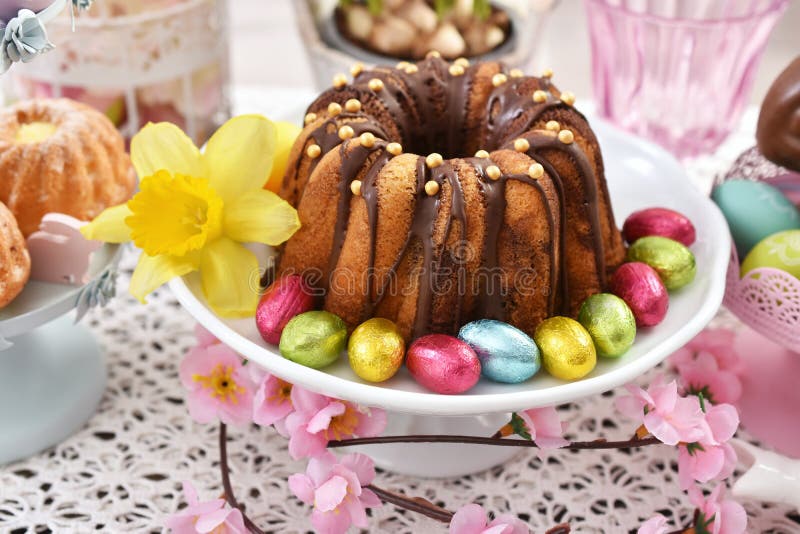 Easter Ring Cake with Candy Eggs and Cookies on Spring Table Stock ...