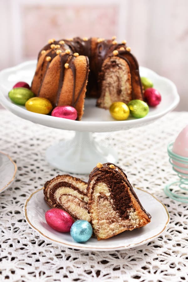 Easter Ring Cake with Candy Eggs and Cookies on Spring Table Stock ...