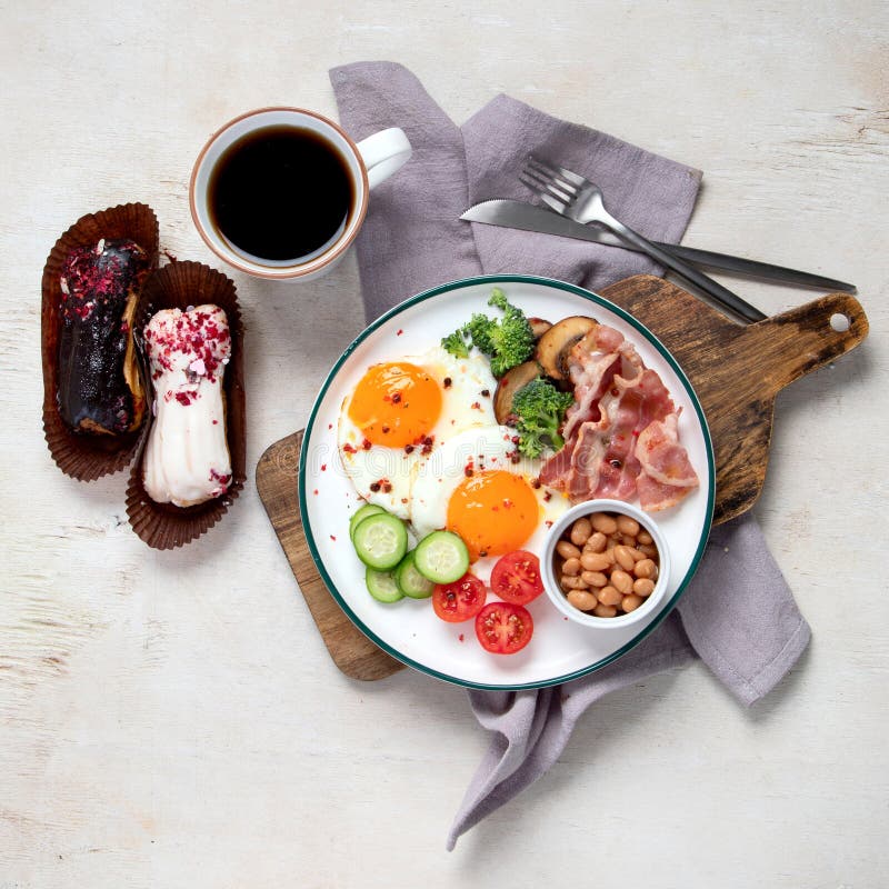 Traditional Englis Breakfast Plate with Bacon Strips, Sunny Side Up ...