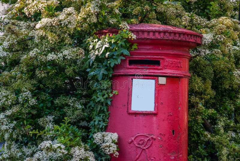 Traditional English Post Boxes with Trees Covered Stock Image - Image ...