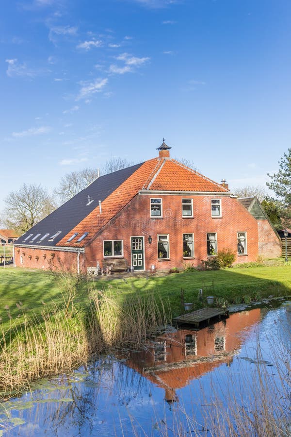 Traditional Farm House with Reflection in the Water in Krewerd Stock ...