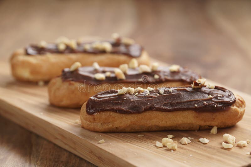 Traditional French Eclairs with Chocolate and Hazelnuts Stock Photo ...