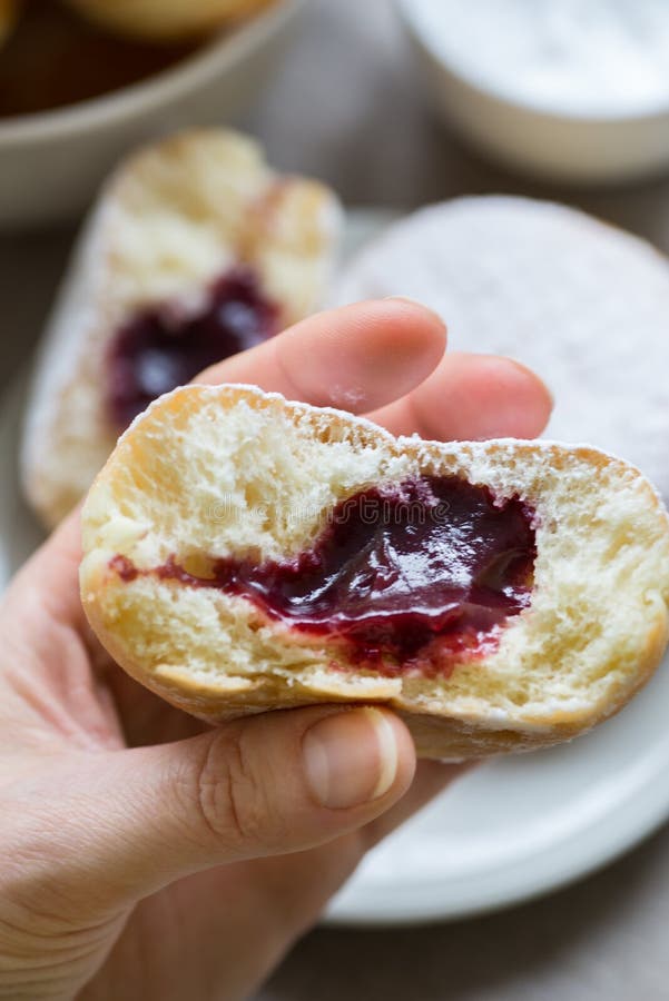 Traditional German Polish Donut with Raspberry Jam Dusted with Icing ...