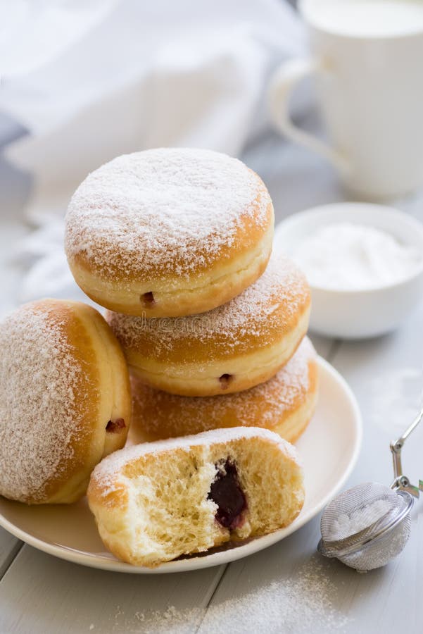 Traditional German Polish Donut with Raspberry Jam Dusted with Icing ...