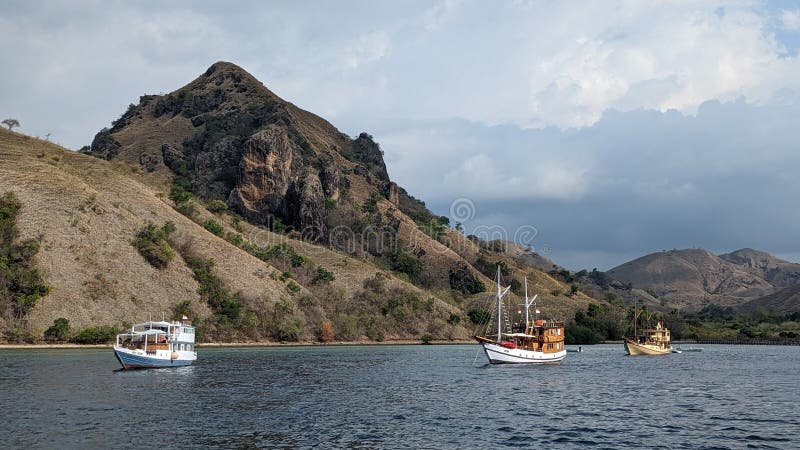 Traditional Indonesian Phinisi in the Sea with Mountain View Stock ...