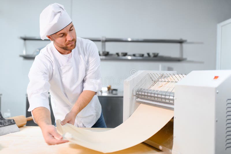 Traditional Italian Food. Side View of Handsome Chef Rolling a Dough ...