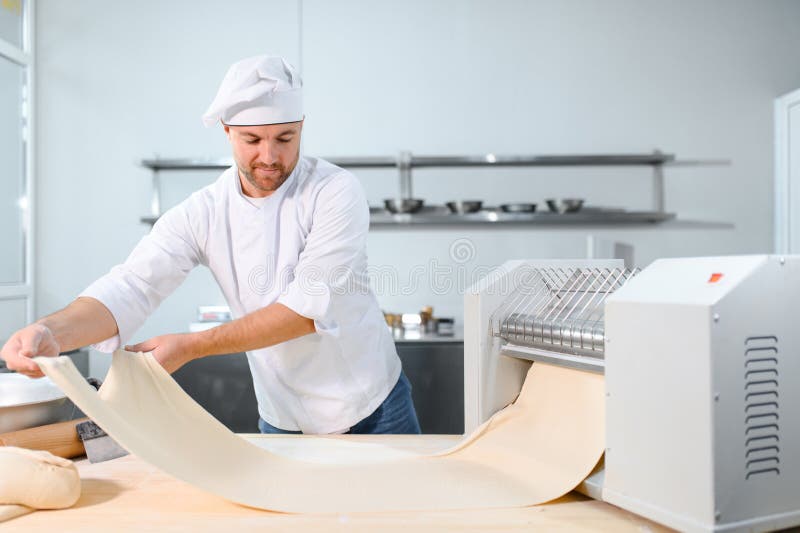 Traditional Italian Food. Side View of Handsome Chef Rolling a Dough ...