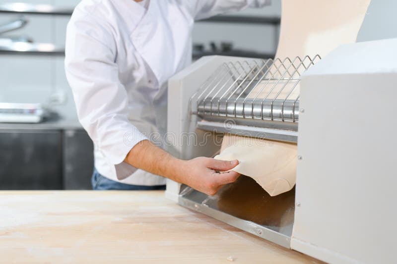Traditional Italian Food. Side View of Handsome Chef Rolling a Dough ...