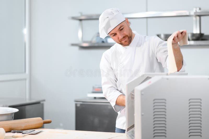 Traditional Italian Food. Side View of Handsome Chef Rolling a Dough ...