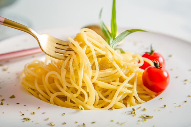 Traditional Italian Pasta with Tomatoes and Basil in Plate with Fork ...