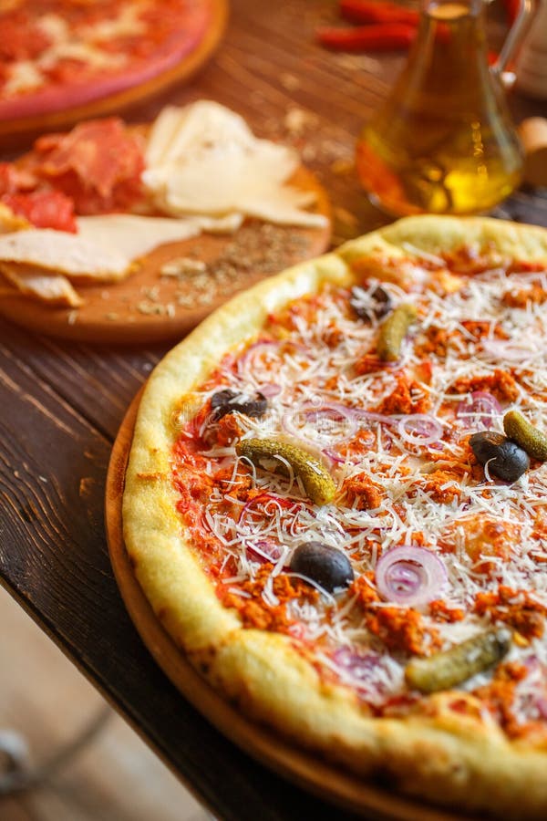Traditional Italian Pizza on a Dark Table with Ingredients. Stock Image ...
