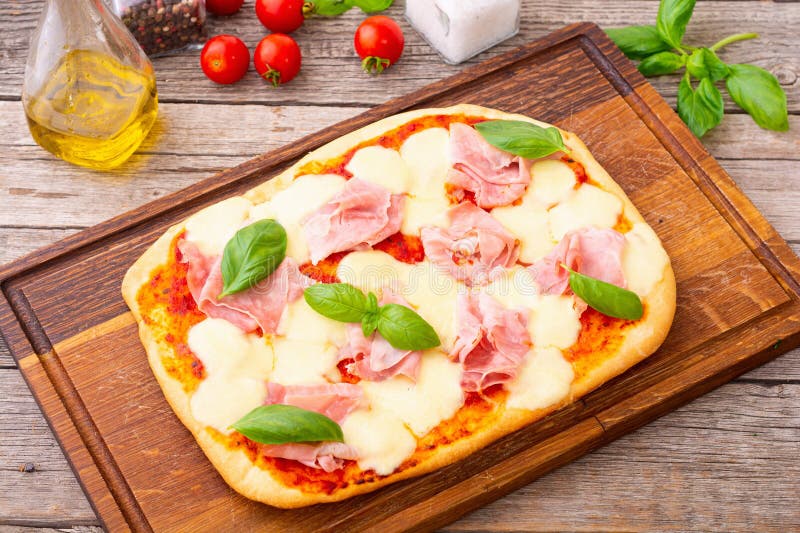 Traditional Italian Pizza with Ham Mozzarella and Basil Stock Photo ...