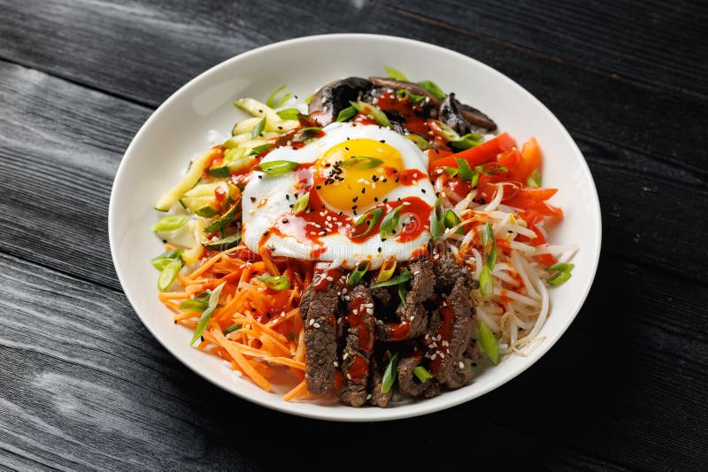 Traditional Korean Dish Bibimbap with Rice, Vegetables Beef and Egg in ...