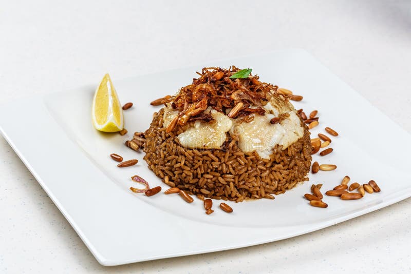 Traditional Middle Eastern Fish and Fried Rice Dish with Fried Pine ...