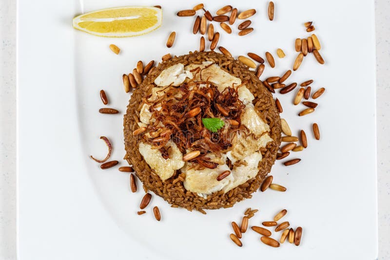 Traditional Middle Eastern Fish and Fried Rice Dish with Fried Pine ...