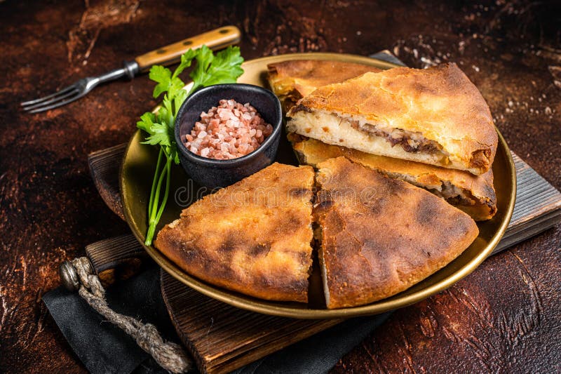 Traditional Ossetian Pie Sliced on a Plate. Dark Background Stock Photo ...