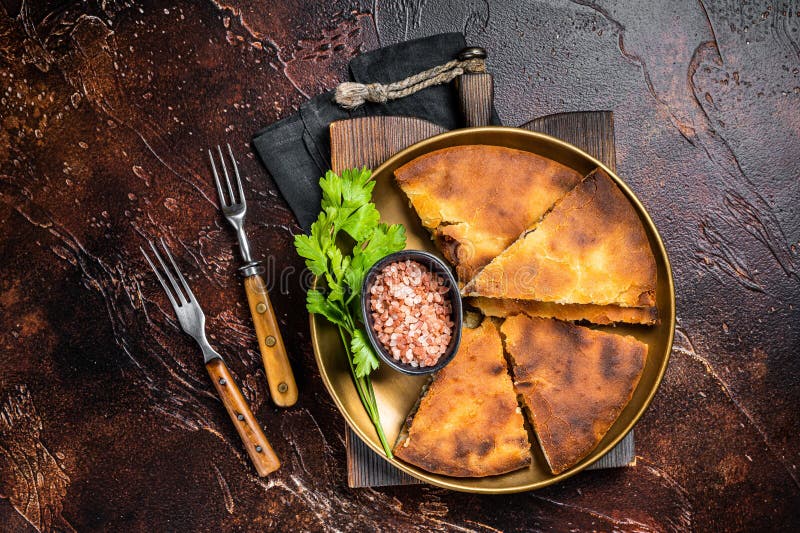 Traditional Ossetian Pie Sliced on a Plate. Dark Background Stock Photo ...