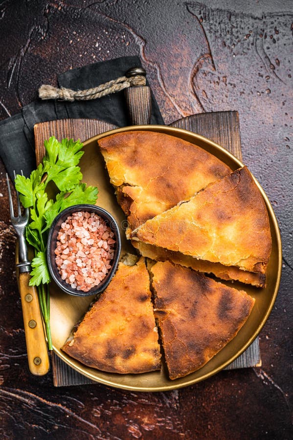 Traditional Ossetian Pie Sliced on a Plate. Dark Background Stock Photo ...
