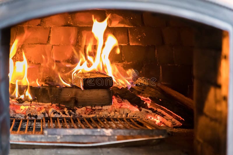 A Traditional Oven with a Burning Fire Inside for Cooking. Firewood and ...