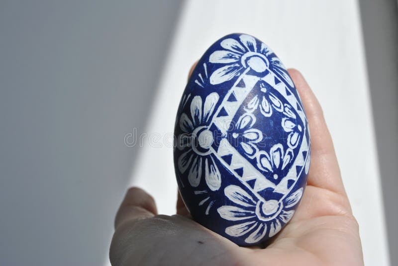Traditional Patterns Decorated Blue Easter Egg in Hand. Stock Photo ...