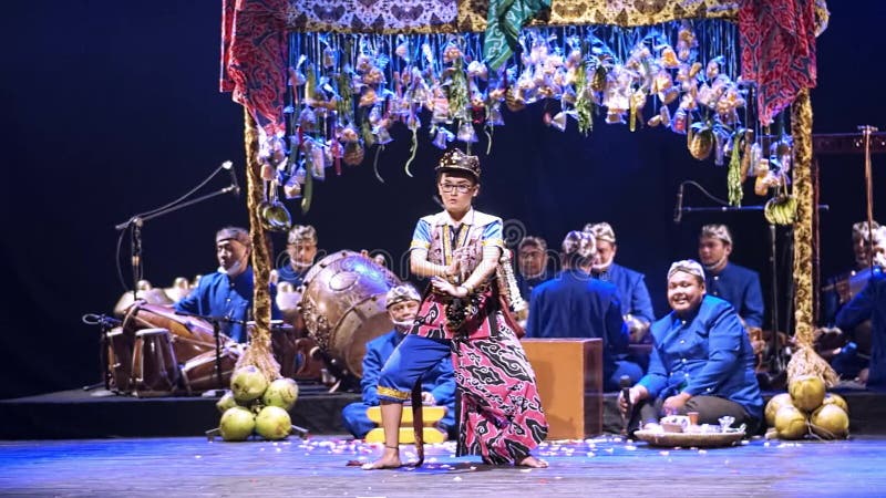 Traditional Performance on Stage with a Central Figure in Costume and ...