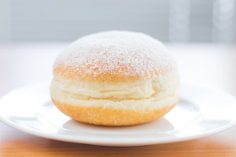 Traditional Polish Paczek with Powdered Sugar on White Plate Stock ...