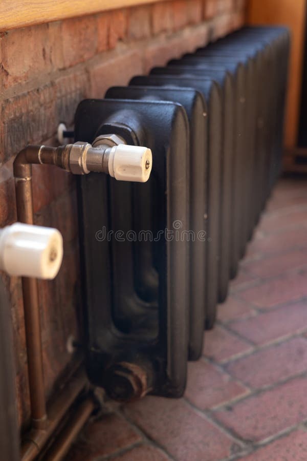 Classic Metallic Radiator Installed in a Cozy Indoor Space with Exposed ...