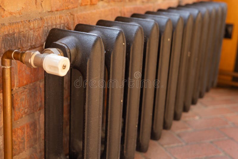 Classic Metallic Radiator Installed in a Cozy Indoor Space with Exposed ...
