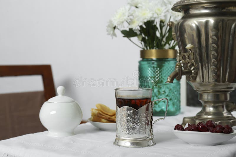 Traditional Russian Samovar, Aromatic Tea and Treats on Table Indoors ...