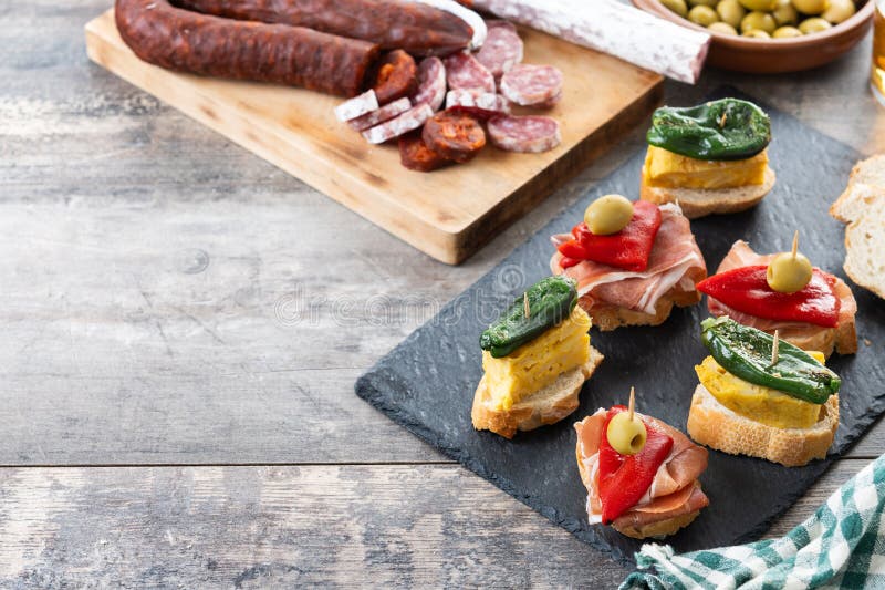 Traditional Spanish Pintxos on Wooden Table Stock Image - Image of cuts ...