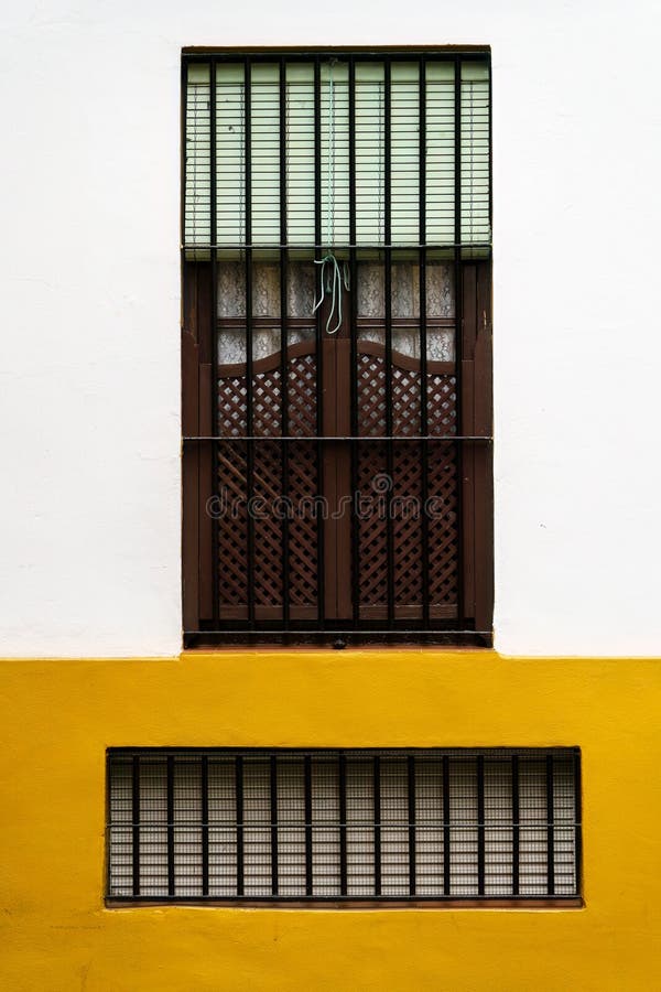 A Traditional Spanish Window with Wooden Shutters and Iron Bars Stock ...