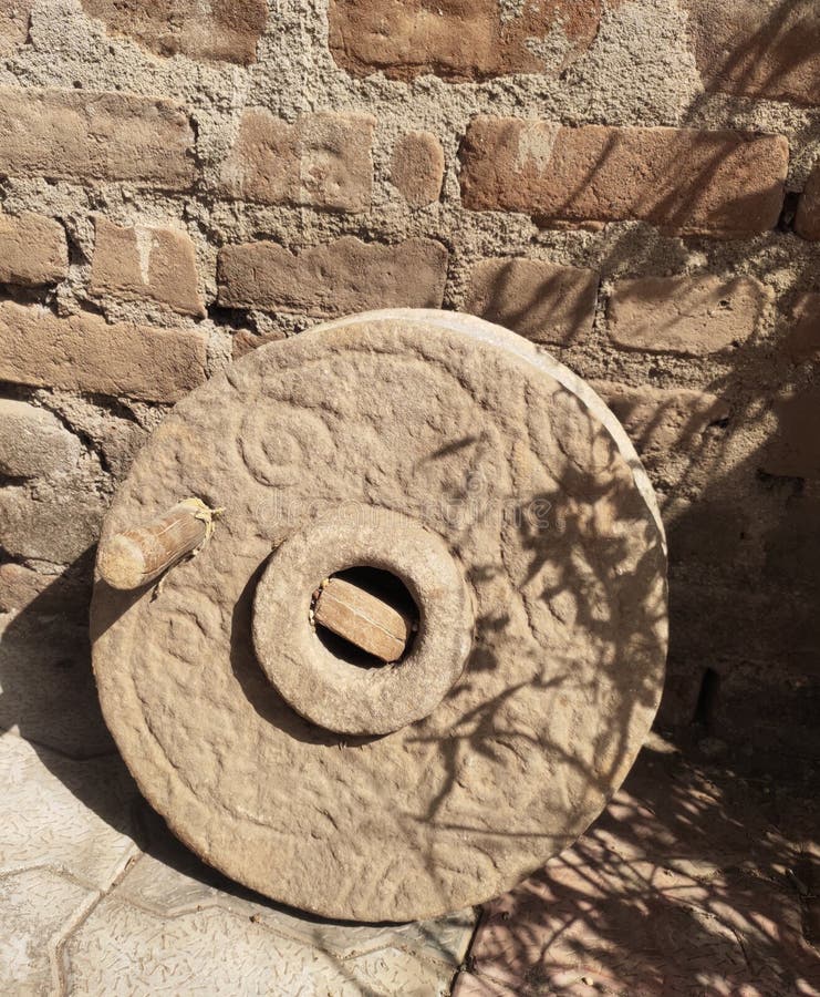 Traditional stone grinder. stock photo. Image of people - 332284162