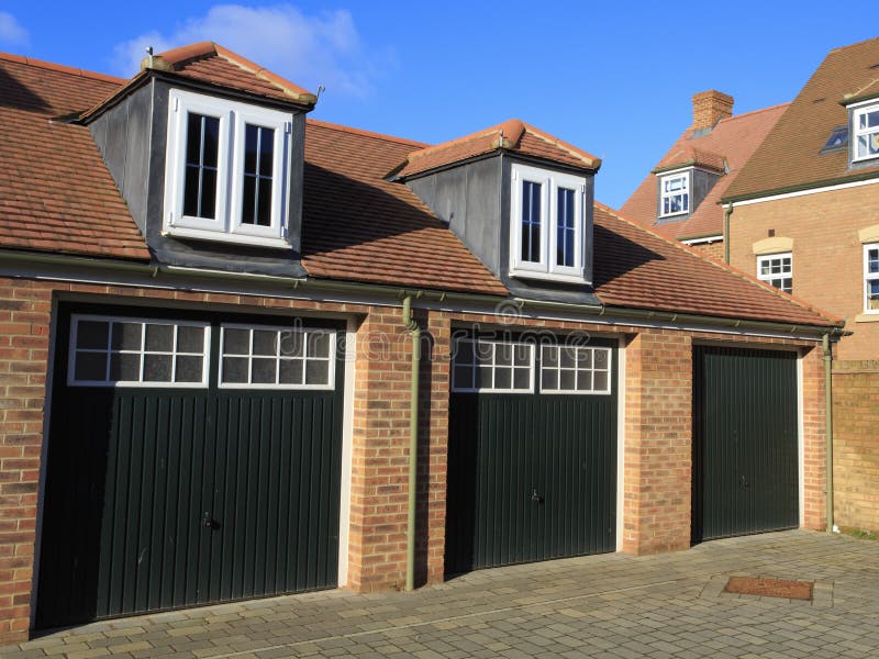 Traditional Style Garages with Wooden Doors and Dormer Windows Stock ...