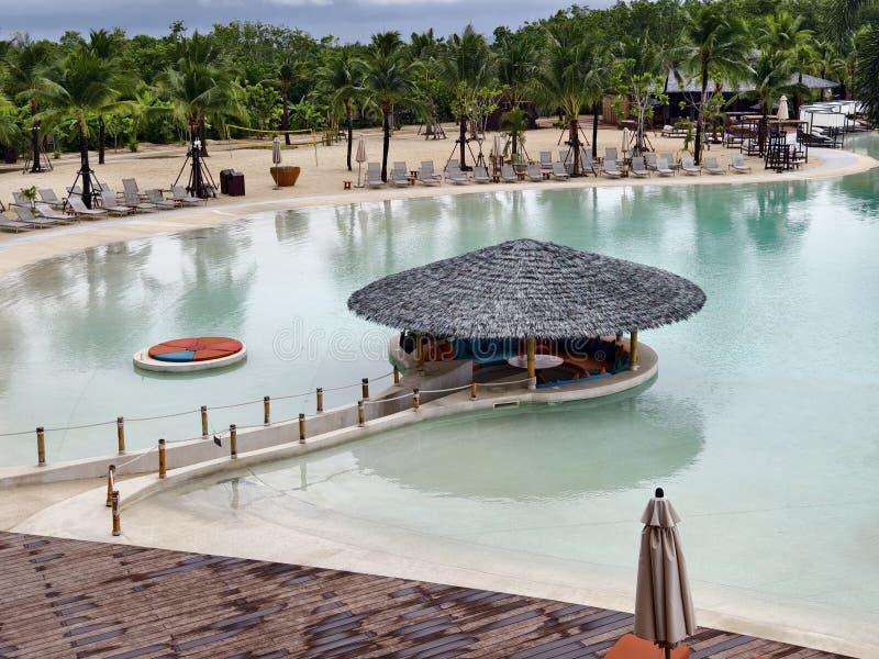 A Traditional Thatched Hut is Located within a Swimming Pool Stock ...