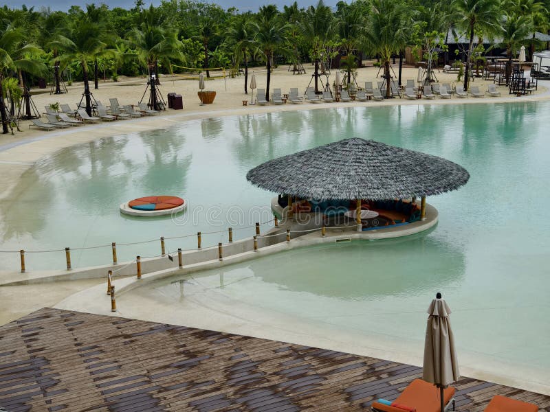 A Traditional Thatched Hut is Located within a Swimming Pool Stock ...