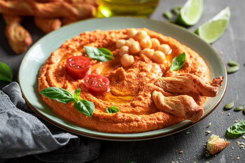 Traditional Tomato Hummus with Breadsticks and Basil Stock Image ...