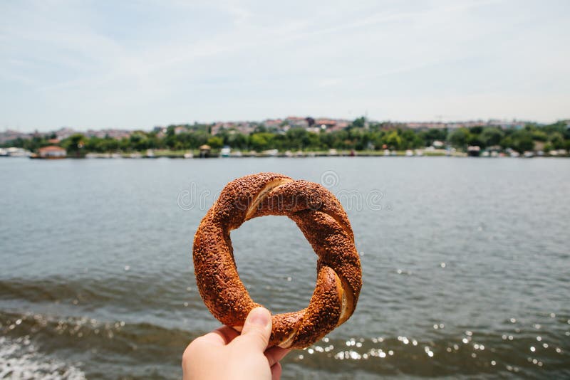The Traditional Turkish Bagel Called Simit is Held by a Man in the Hand ...