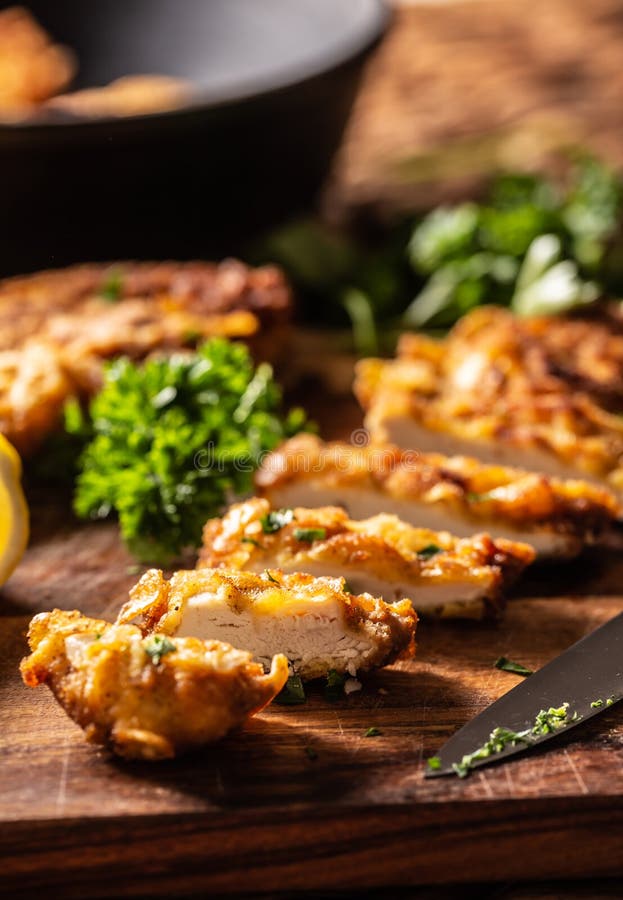 Traditional Viennese Chicken Schnitzel on a Wooden Board Stock Photo ...