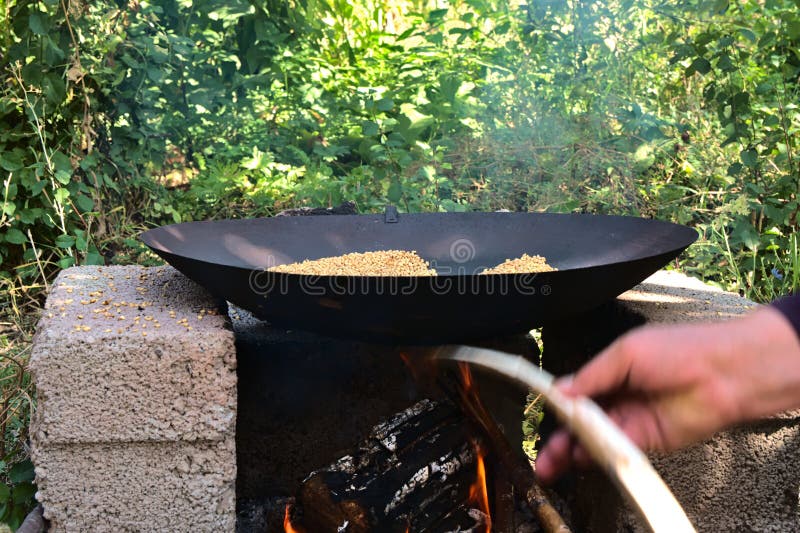 Traditional Way To Roast Wheat on Fire of a Stone Stove Stock Image ...