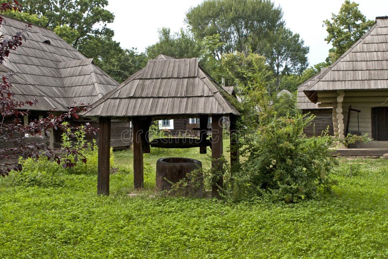 Old farmhouse with a well stock image. Image of building - 70153765