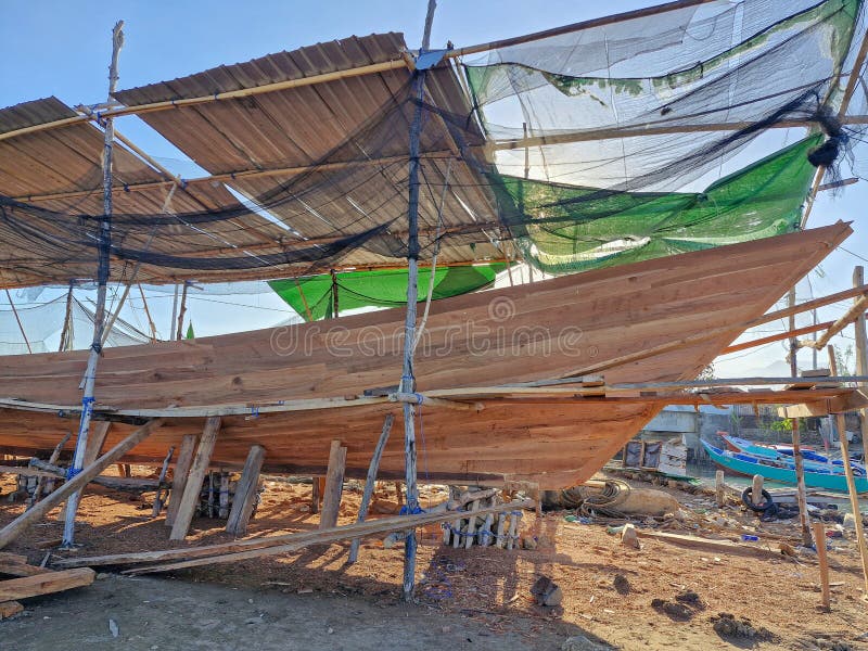 Traditional Wooden Boat Under Construction on a Beach in Indonesia ...